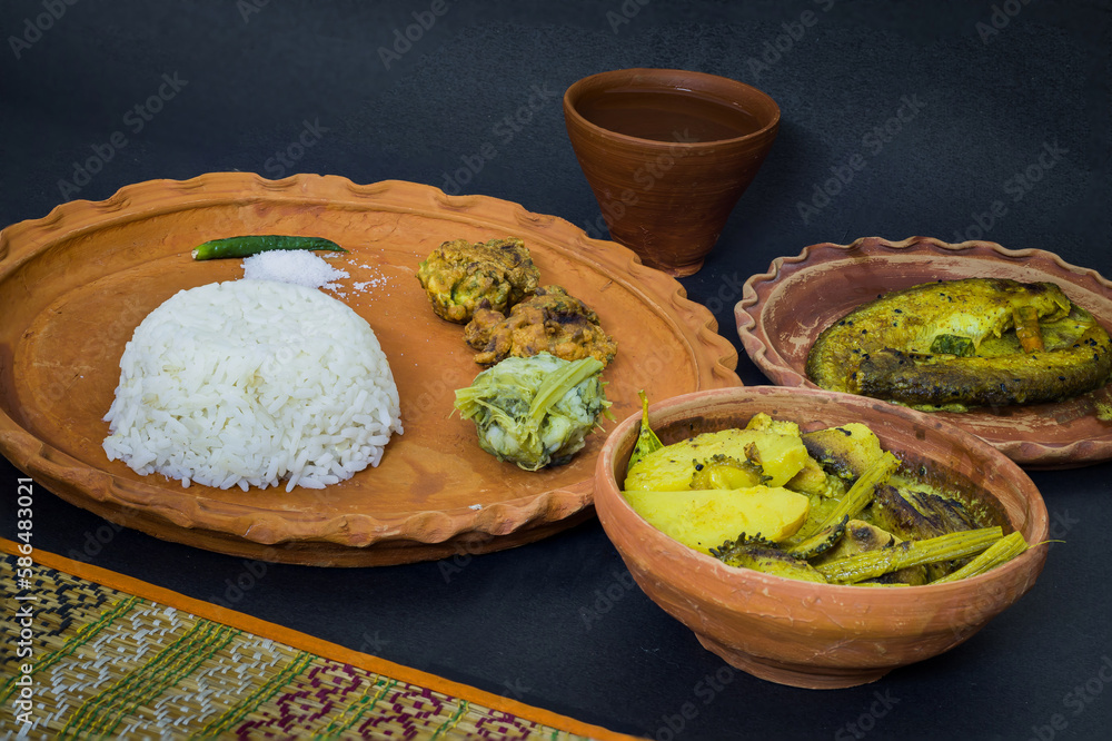 Traditional Bengali indian meal served on clay plate consisting of ...
