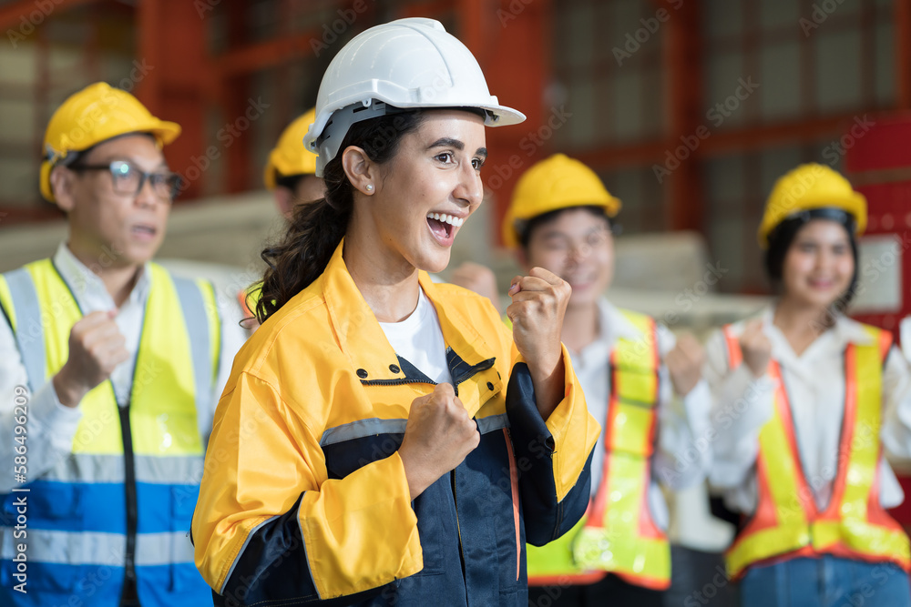 Female factory worker raise hands in industry factory, feeling happy ...