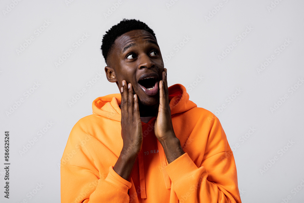 Look there. Excited curious happy african american black man holding ...