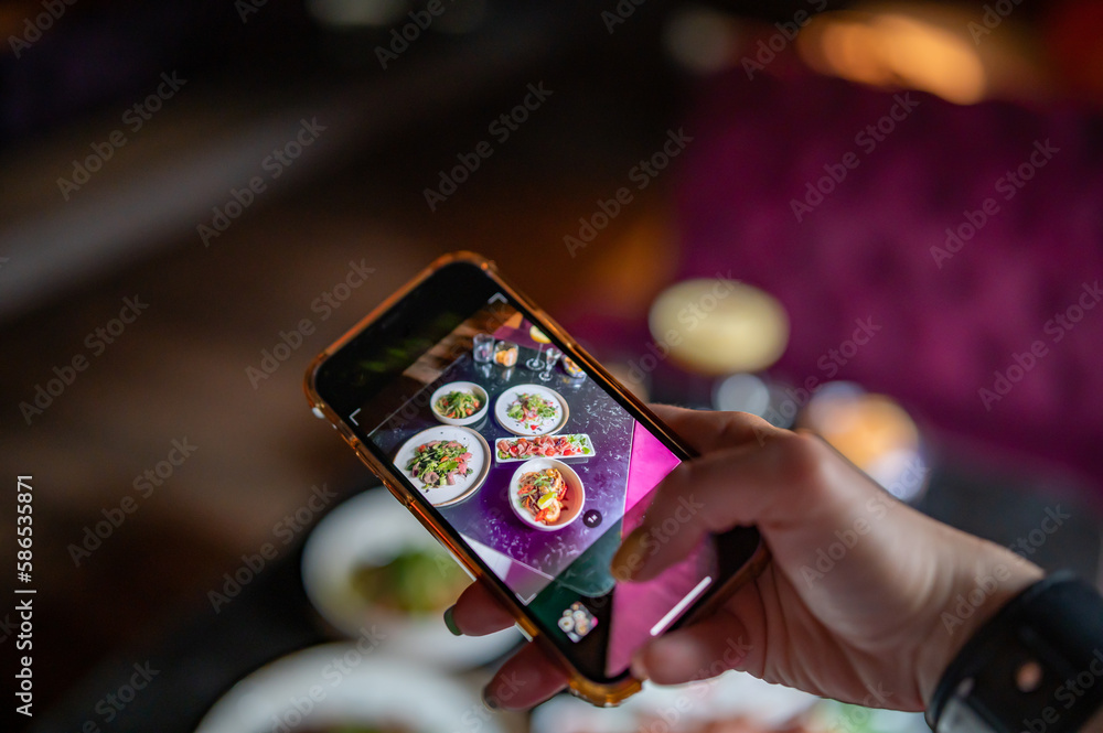 hand with smartphone photographing food at restaurant or cafe Stock ...