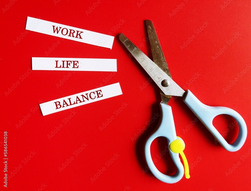 On red background, scissor cut paper with text WORK LIFE BALANCE ...