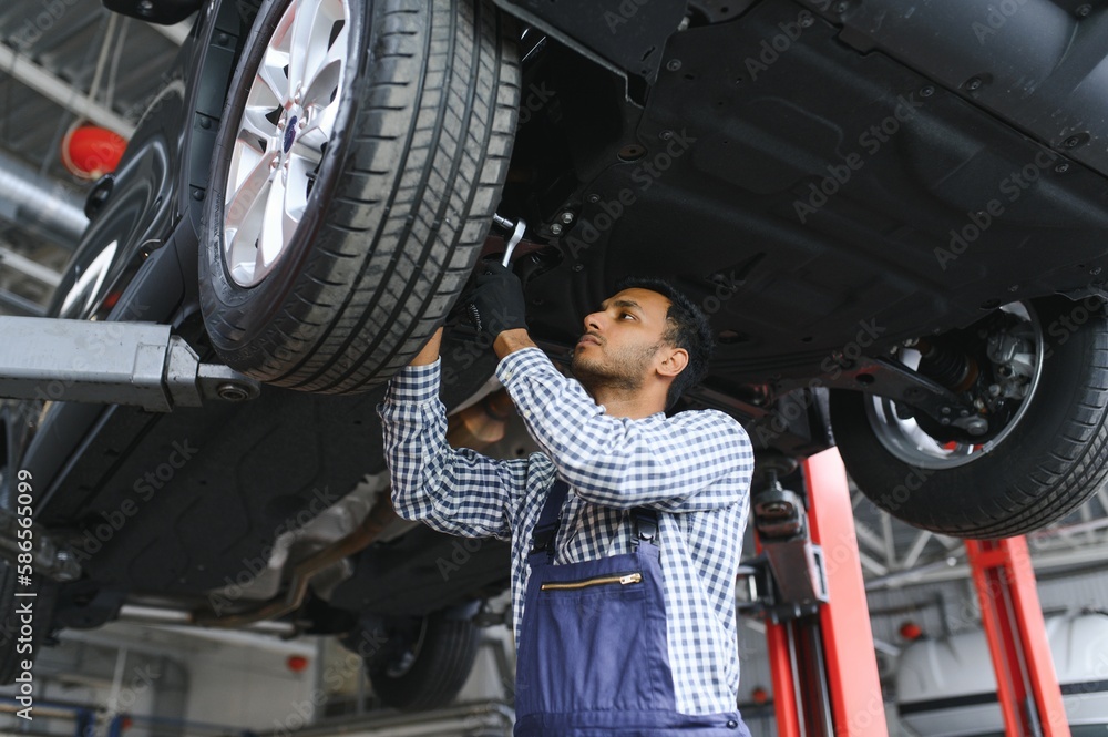 Indian happy auto mechanic in blue suit. Stock Photo | Adobe Stock