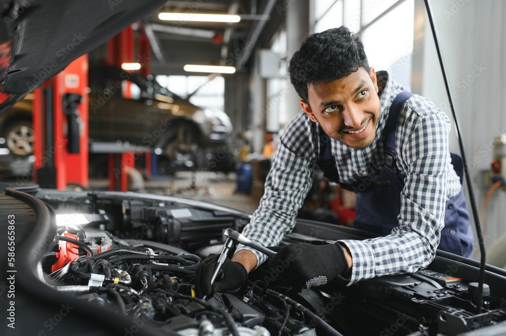 Indian car mechanic standing and working in service station. Car ...
