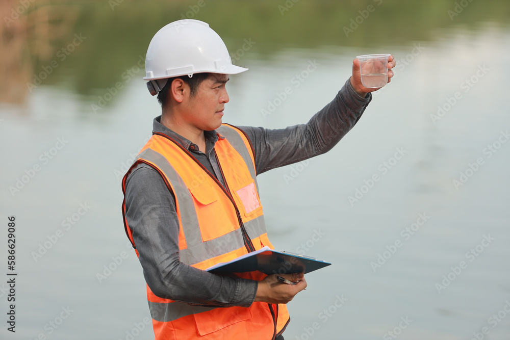 Environmental engineers work at water source to check for contaminants ...