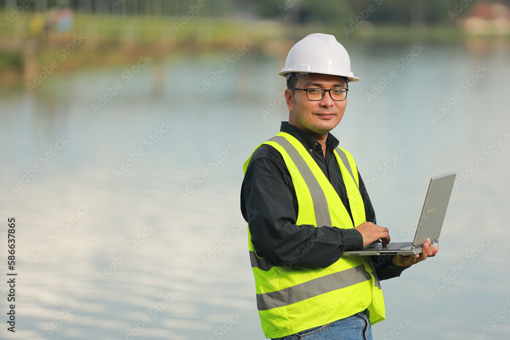 Environmental engineers work at water source to check for contaminants ...