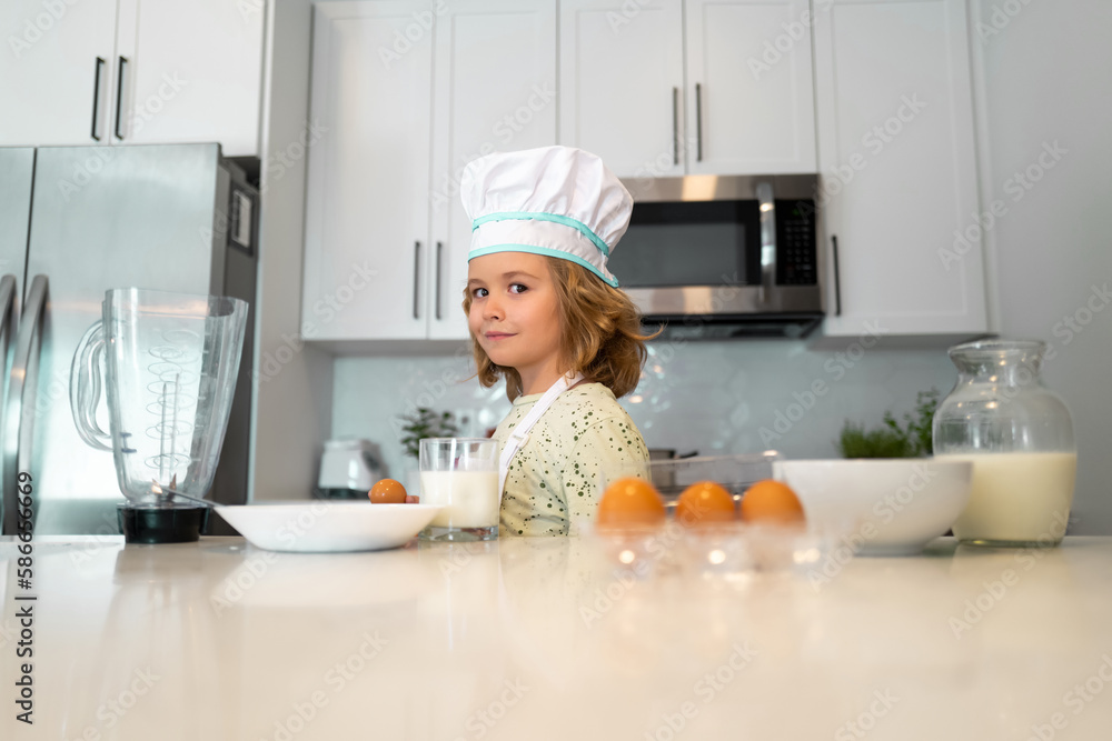 Kid chef cook cookery at kitchen. Portrait of little child in uniform ...