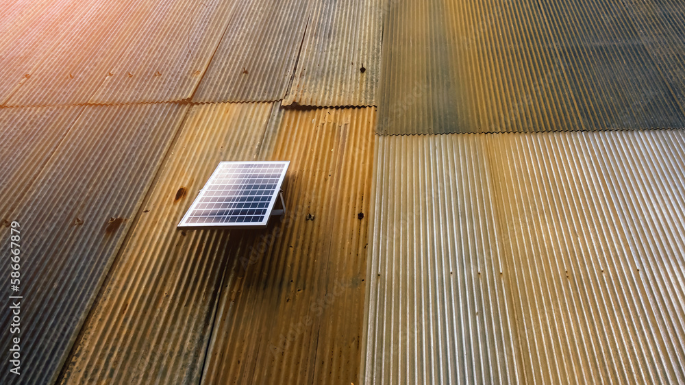 Solar panel attached on old zinc wall. Electric solar panel on the ...