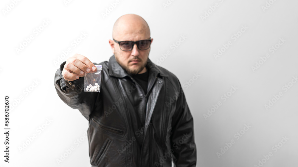 Dangerous bald man in black leather jacket and sunglasses holding ...
