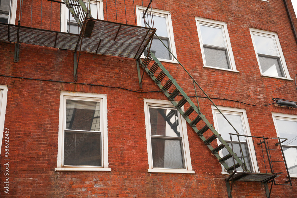 view of fire escapes on buildings and houses. A series of metal ladders ...