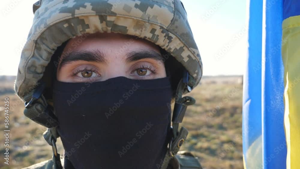 Close up brown eyes of male ukrainian army soldier in helmet and ...