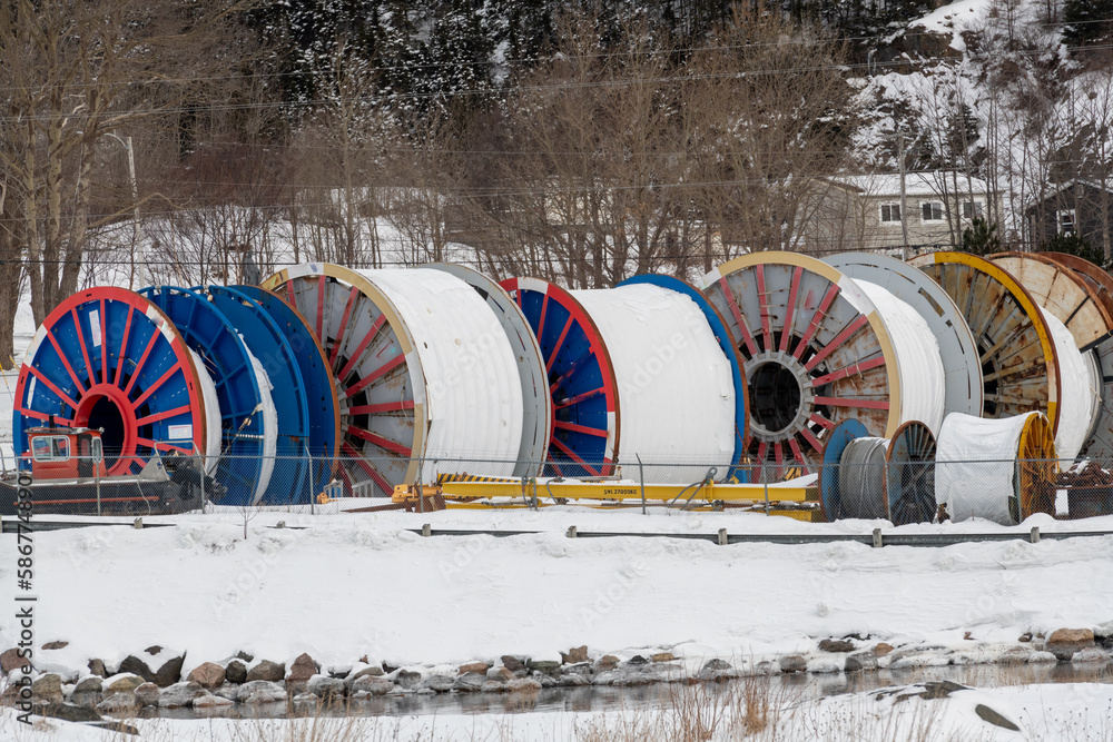 Bulk sub-sea industrial glass fiber optic cable on a metal spool on ...