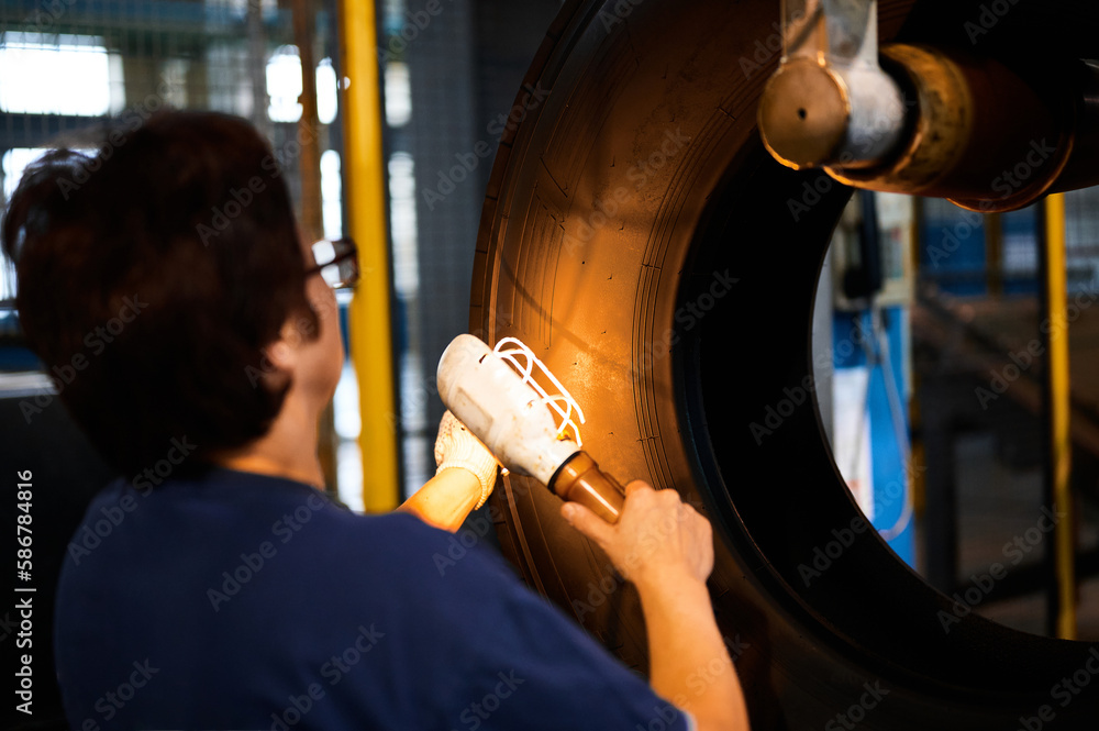 Visual quality control of the manufactured car tire. Stock Photo ...