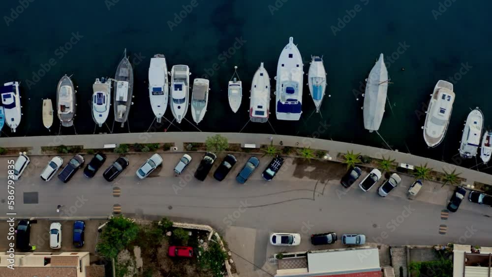 The aerial view of a yacht berth from the top showcases a colorful and ...