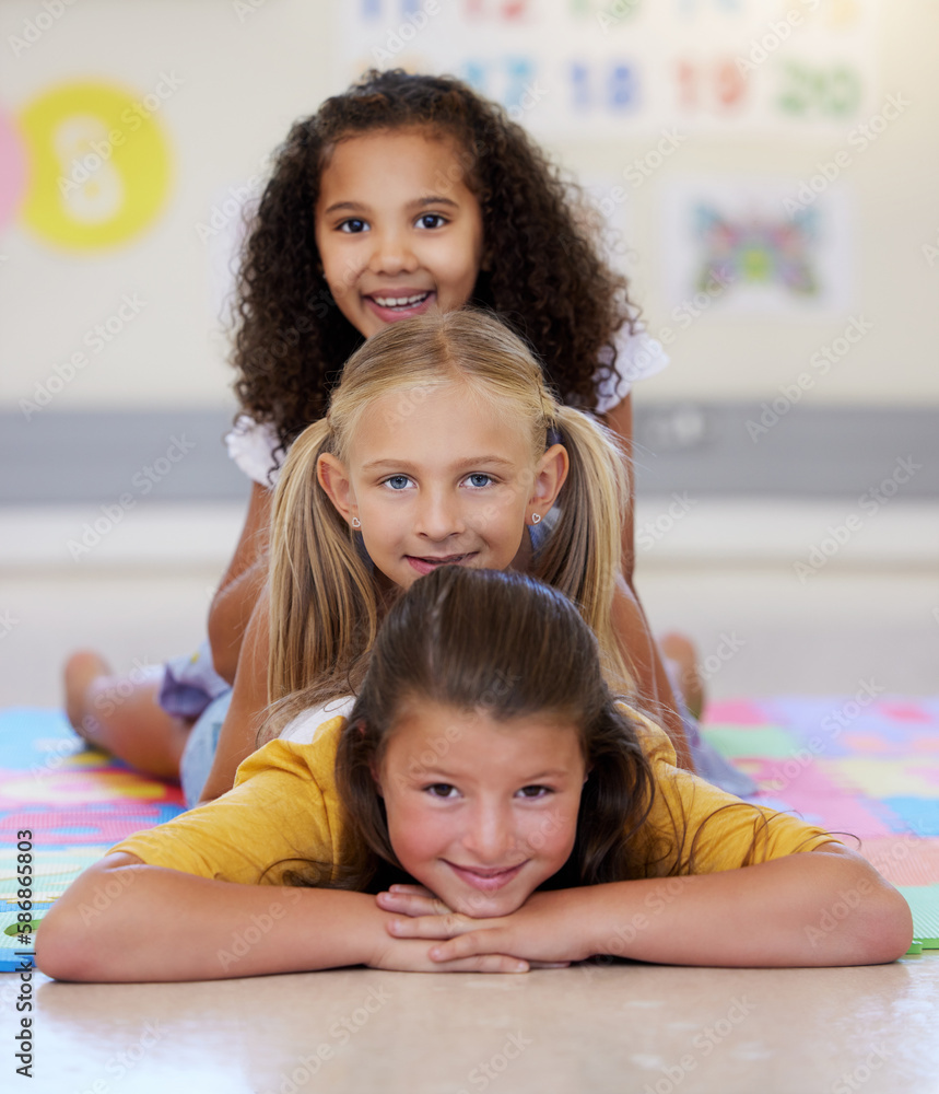 School kids, lying together and pile on floor, portrait and classroom ...