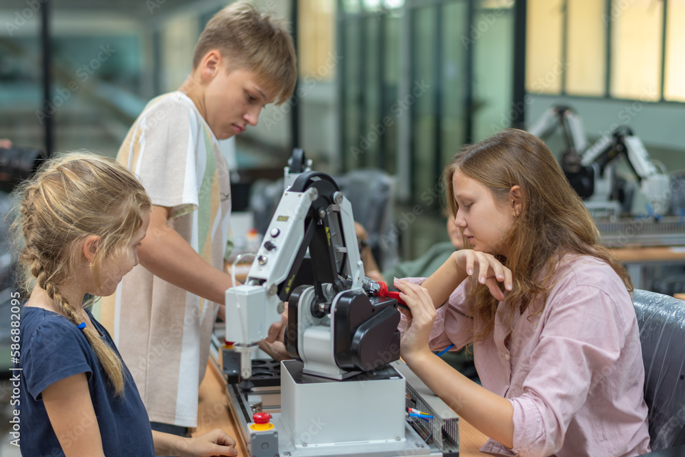 Group Kid teen child enjoy Machine Learning Robot arm is Moving Under ...