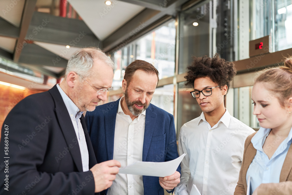 Business people from consulting team read business plan Stock Photo ...