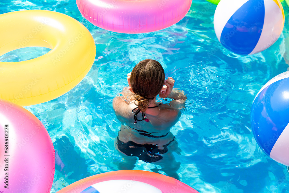 Foto de Inflatable life buoys in the pool of teenage girls in bikini ...