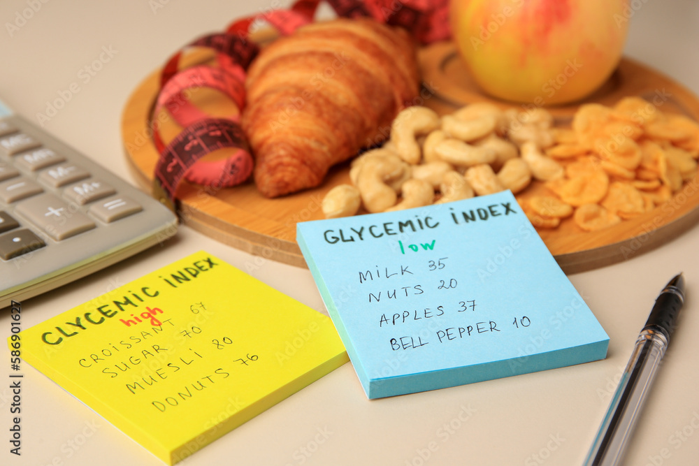 Glycemic index. Notes with information, measuring tape, calculator, pen ...