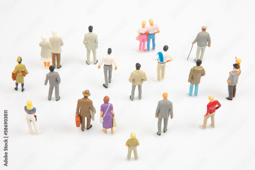 miniature people. different people stand on a white background ...