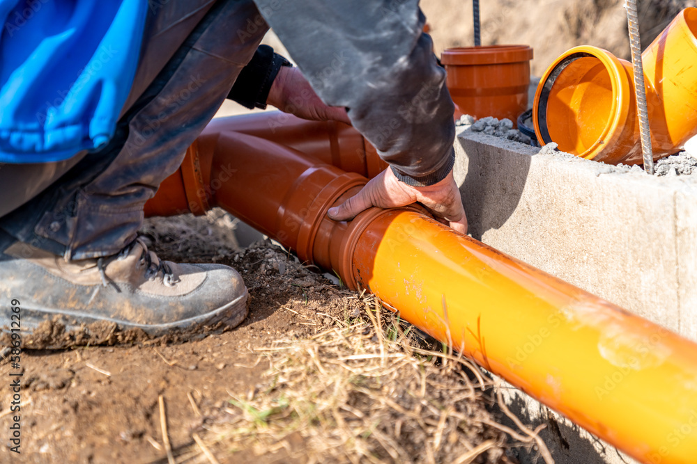 installation of a sewage plastic pipe during the construction of a ...