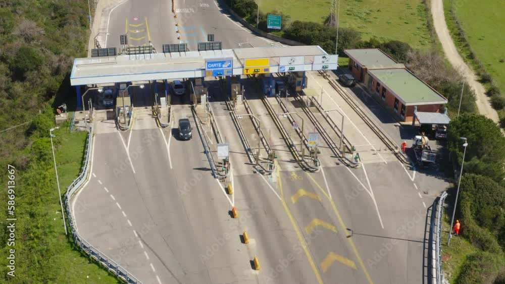 Aerial view of an Italian highway toll booth. There are lanes for ...