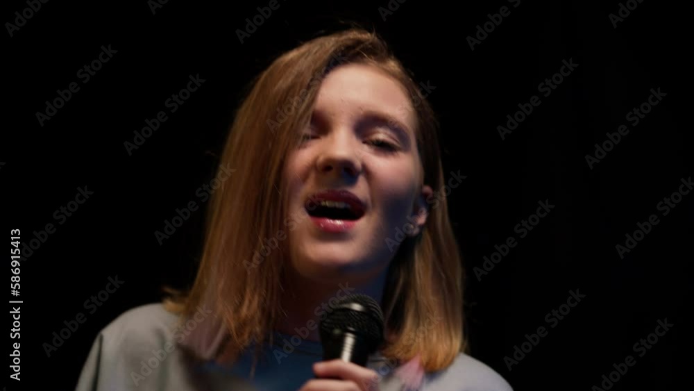 Live camera moves up and down microphone in hands of talented confident ...