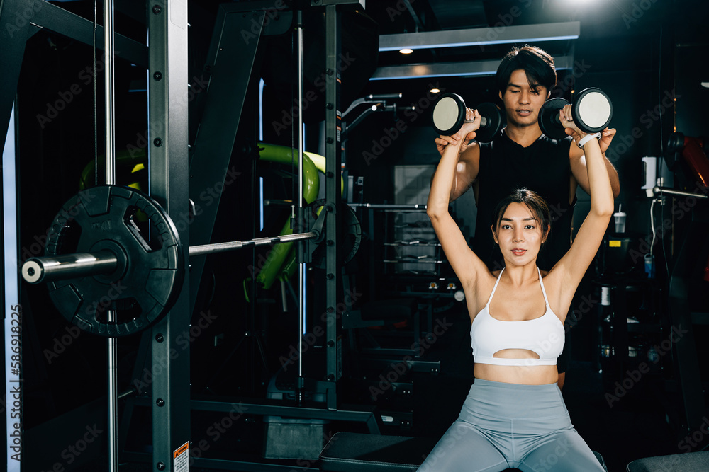 Asian fitness instructor teaching a group of adults the proper form and ...