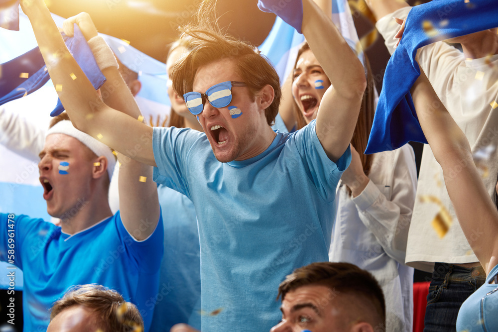 Sport fans with flags and paintings on faces, emotionally cheering up ...