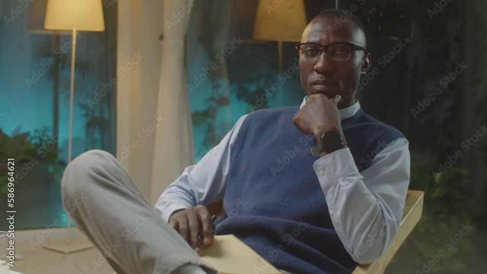 Medium long shot of black male psychologist sitting in his office in ...