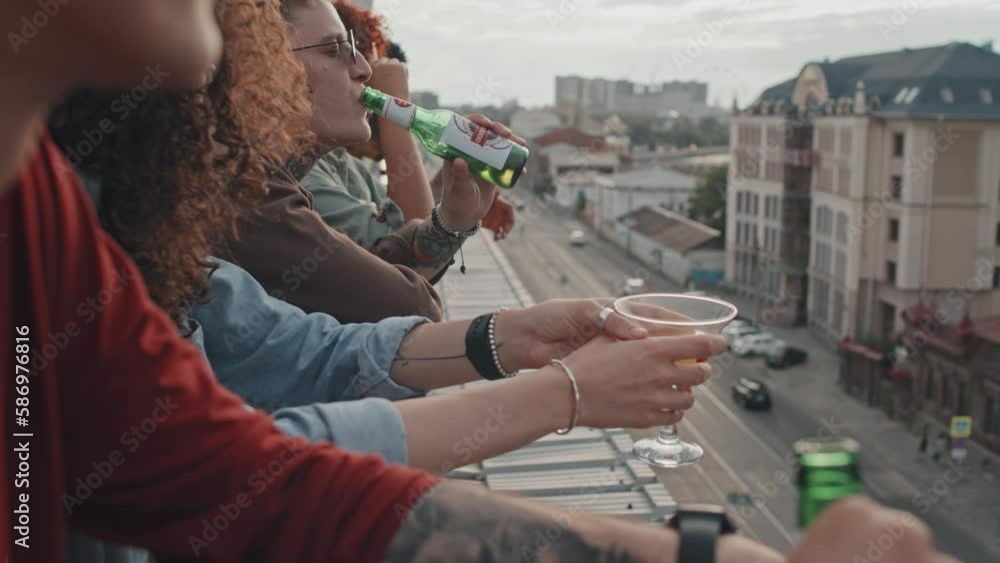 Group of modern ethnically diverse gen Z friends hanging out at rooftop ...