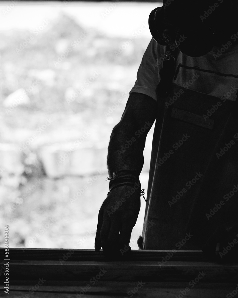 A young man working as carpenter in his wood workshop. Wood worker ...