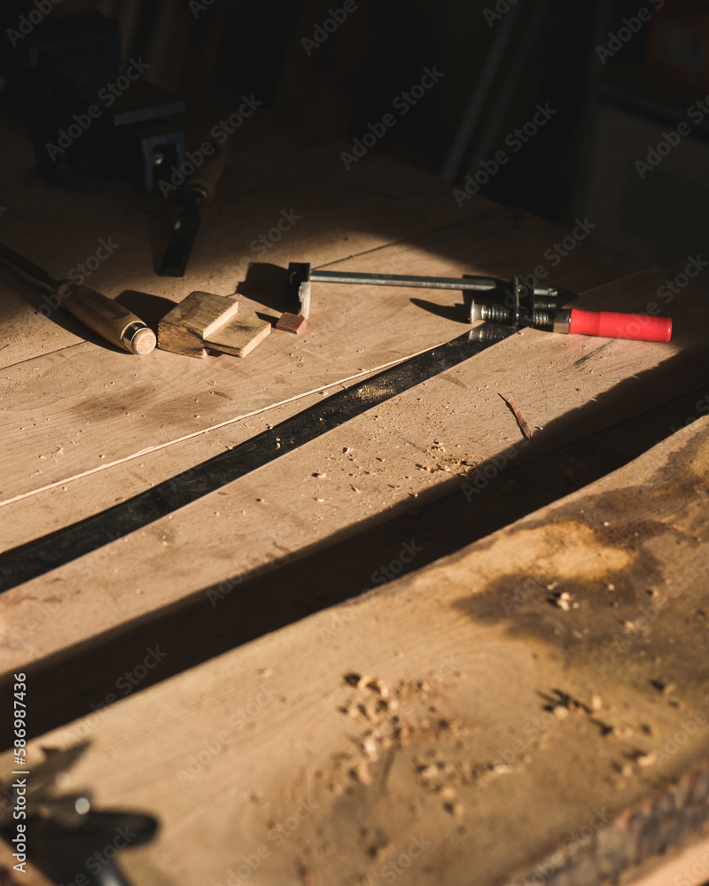 A carpenter office desk inside a small carpentry workshop showing tools ...