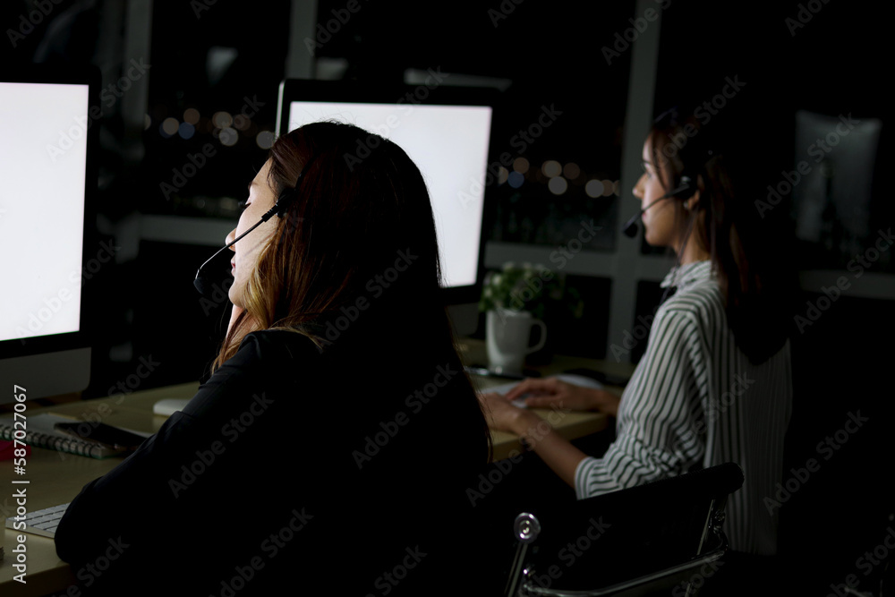 Foto de Back side of night shift staff group with headphone work at ...