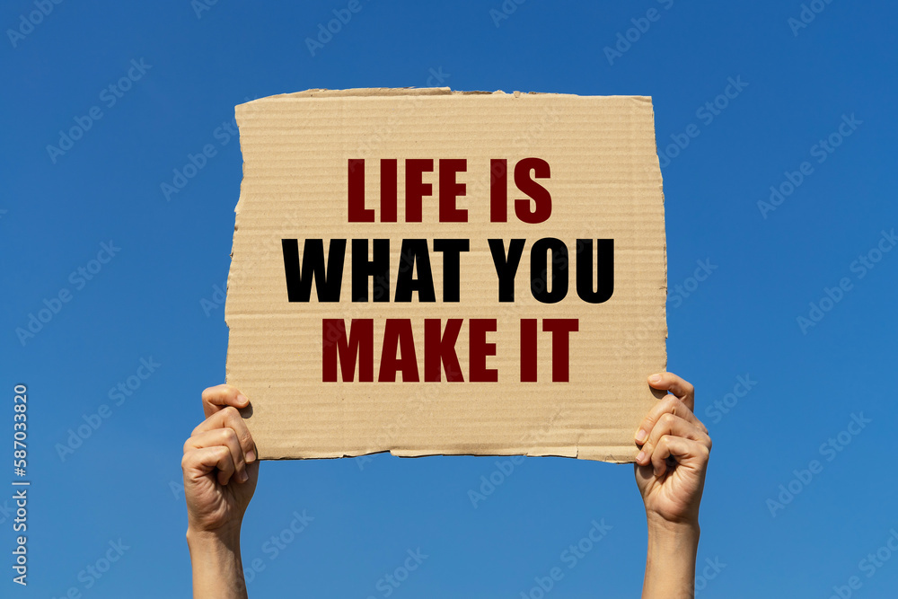 Life is what you make it text on box paper held by 2 hands with ...