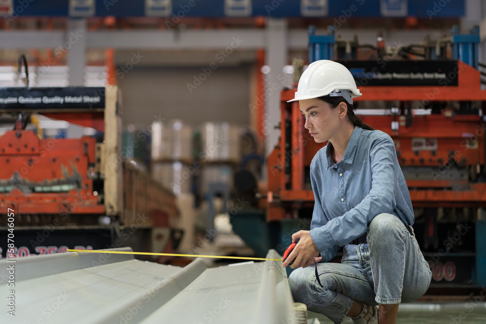 Metalwork manufacturing in plant. Female factory worker inspecting ...