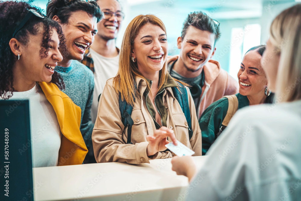 Foto de Group of young people takes room key card at check-in of youth ...