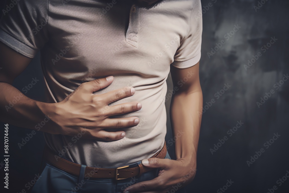 Man suffering from a stomach ache or food poisoning. Holding belly and ...