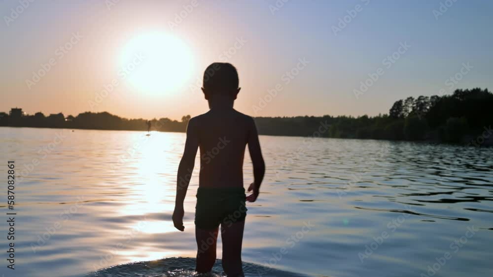 Little boy goes into the water to swim. 4k slow motion footage UHD ...