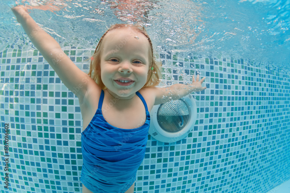 Happy family have fun in swimming pool. Funny child swim, dive in pool ...