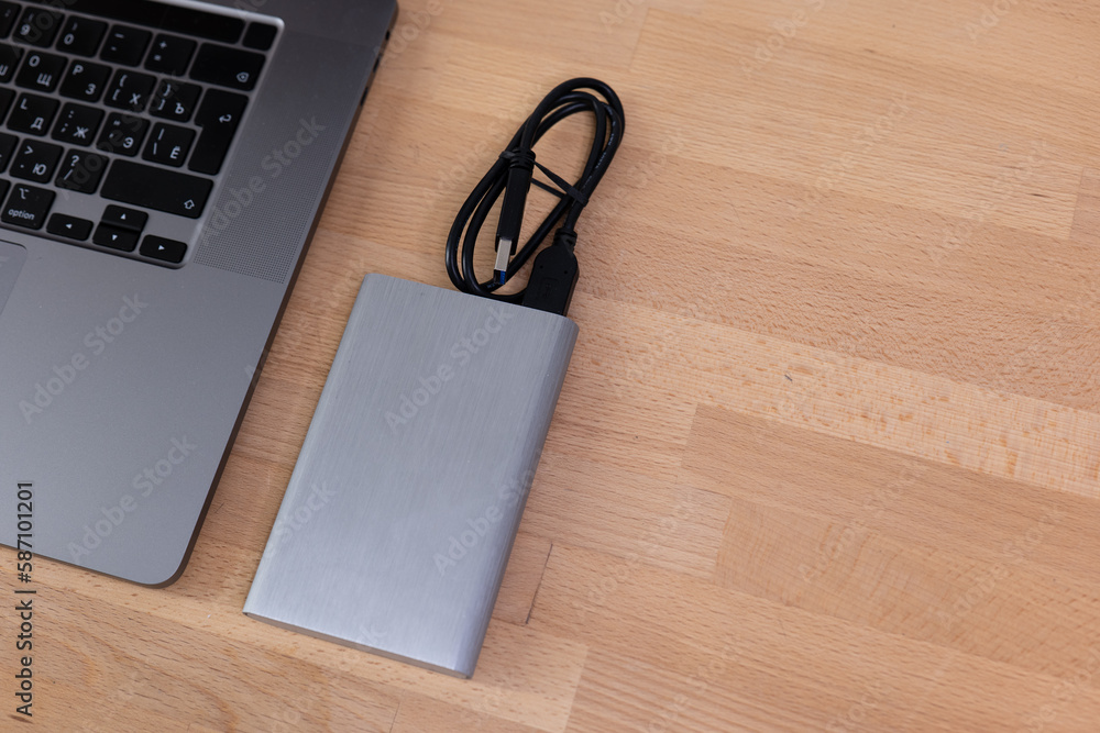 External hard drive connected to laptop computer. Portable hard drive ...