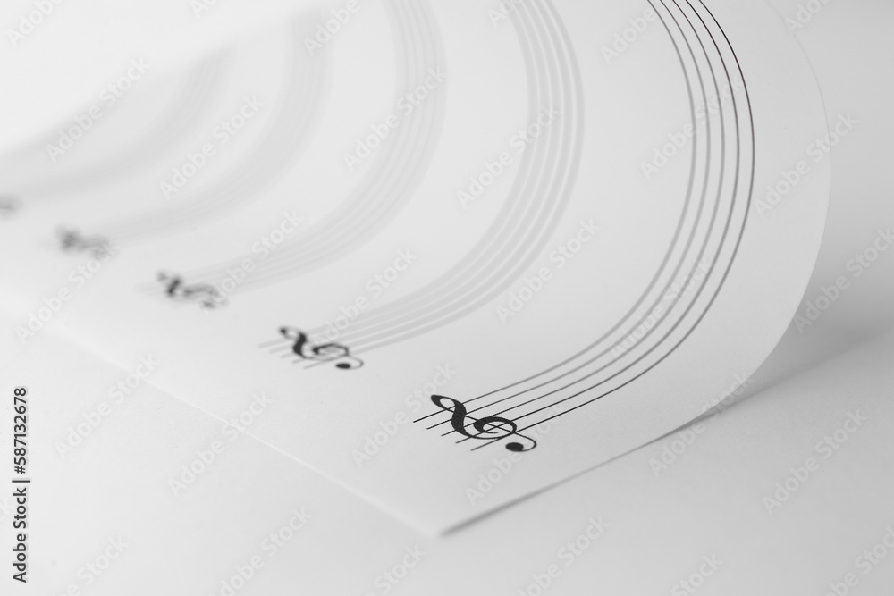 Sheet with empty staves for music notes and treble clef on white ...