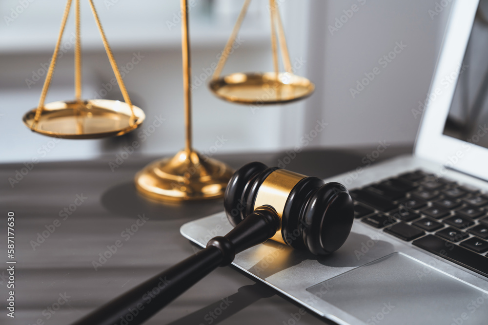 Symbolizing justice and legal authority, golden balanced scale and ...