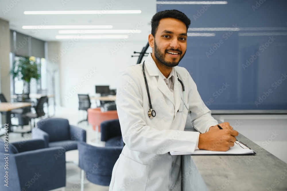 Portrait of happy friendly male Indian latin doctor medical worker ...