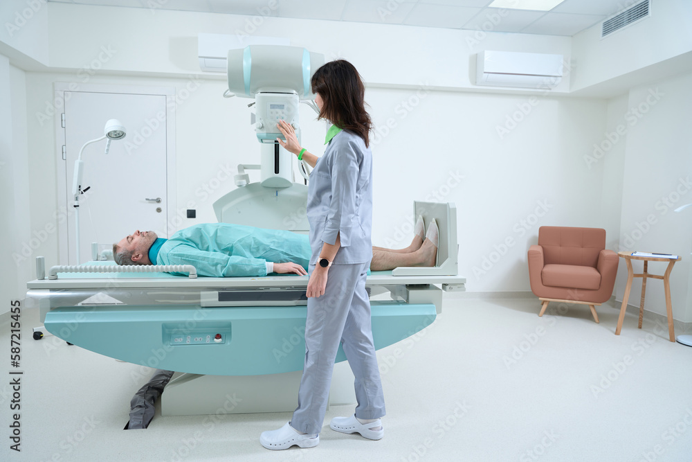 Female radiologist controling X-ray process in clinic Stock Photo ...