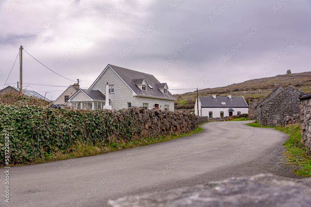 Road by old cottage in the village of Inishmore island Stock Photo ...