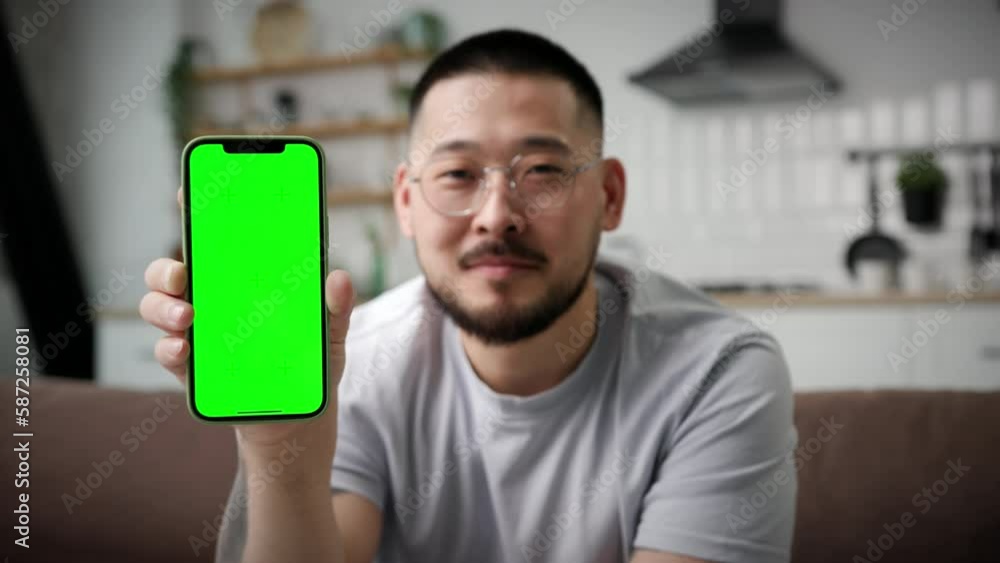 Man In Googles Holding Green Screen Mobile Phone At Camera. Smiling ...