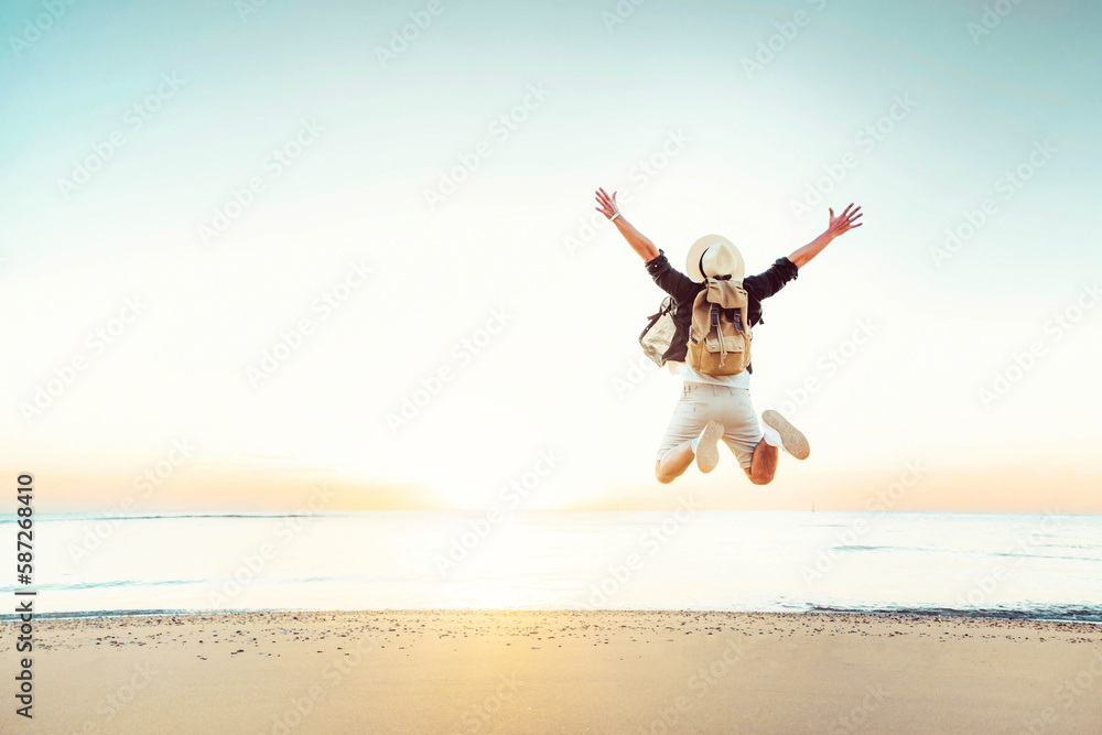 Happy traveler enjoying freedom jumping at the beach - Cheerful hiker ...