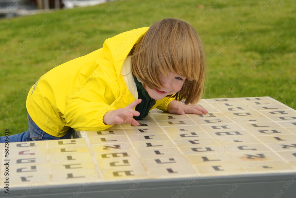 Little boy looks up the Hebrew alphabet. Learning with play. Hebrew ...