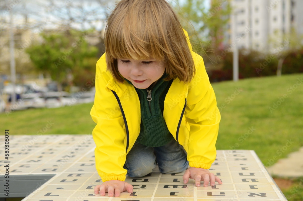 Little boy looks up the Hebrew alphabet. Learning with play. Hebrew ...