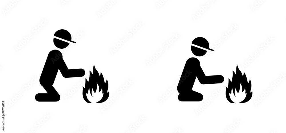 Man sits by the campfire, warms his hands. Man with fire flame. Stop ...